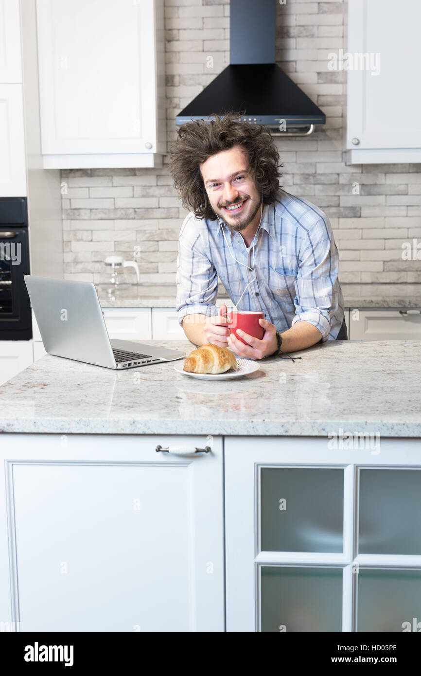Man Eating Breakfast Using Laptop, Man in kitchen drinking coffe Stock ...