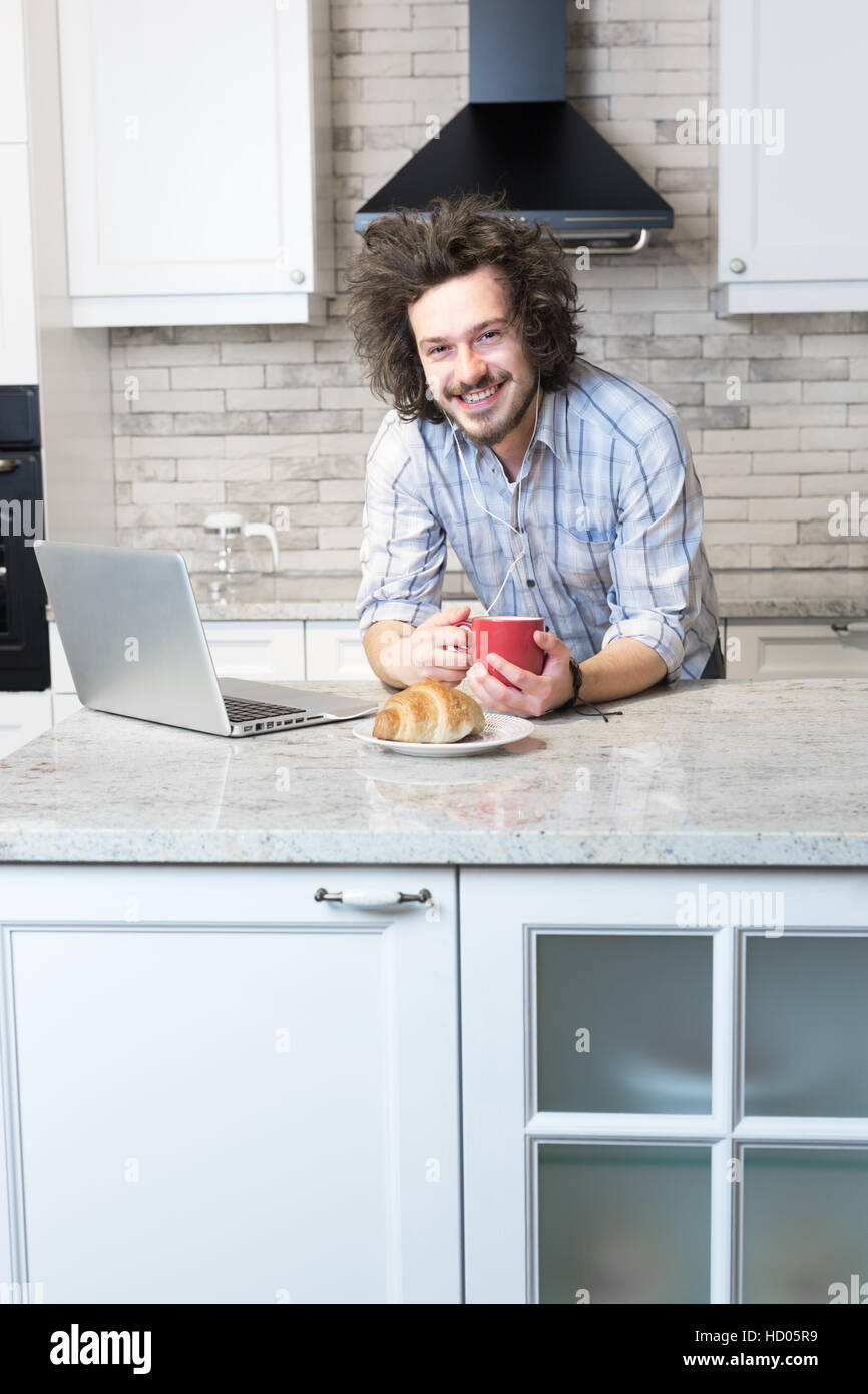 Man Eating Breakfast Using Laptop, Man in kitchen drinking coffe Stock ...