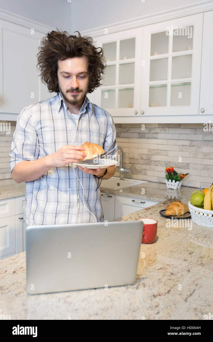 Man Eating Breakfast Using Laptop, Man in kitchen drinking coffe Stock ...