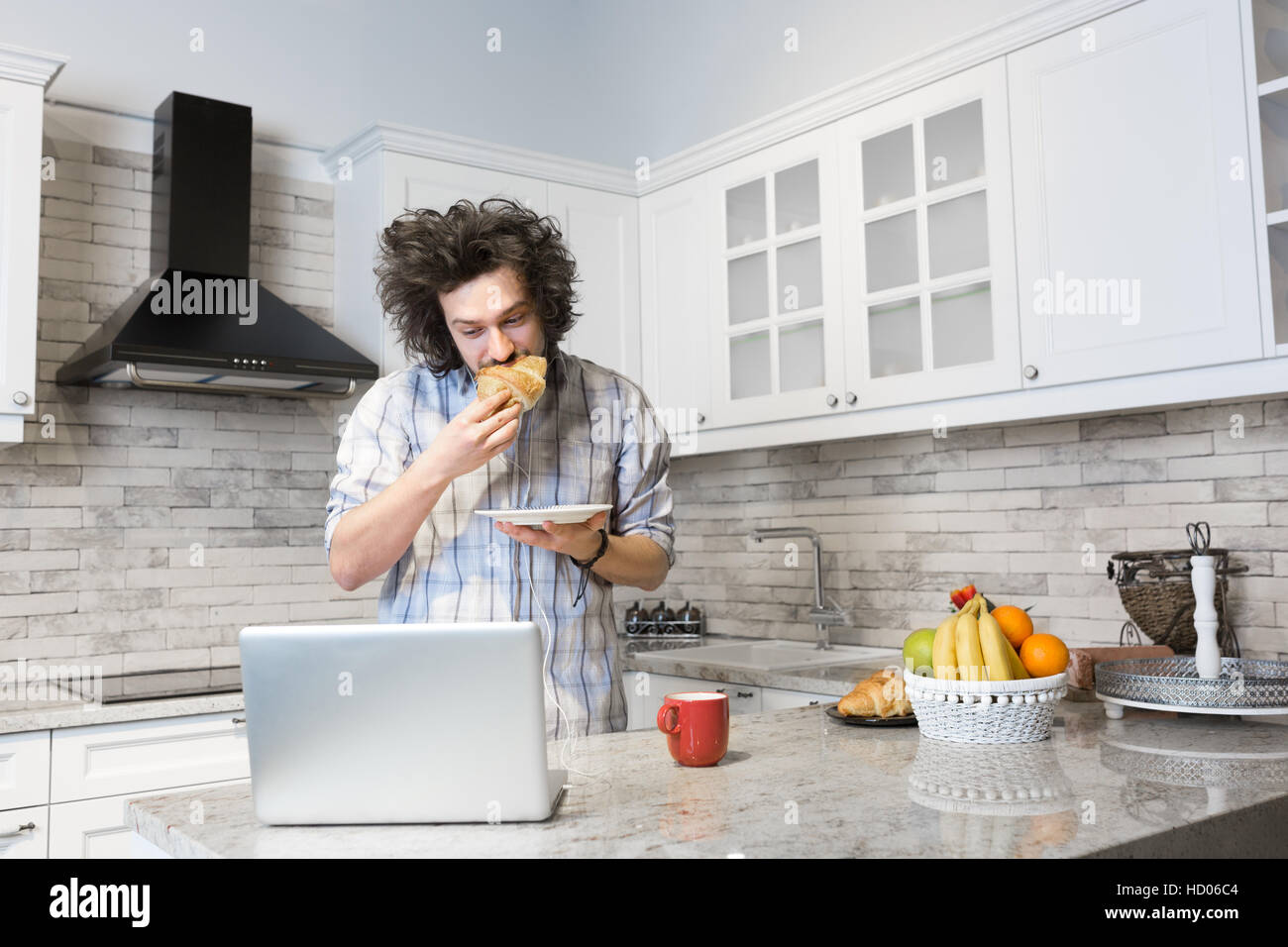 Man Eating Breakfast Using Laptop, Man in kitchen drinking coffe Stock ...