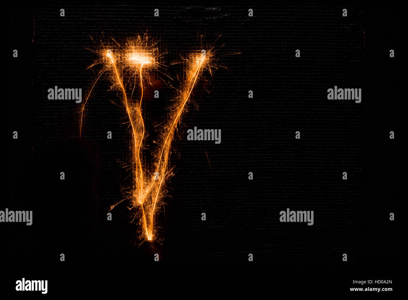 Letter V made of sparklers on black Stock Photo - Alamy