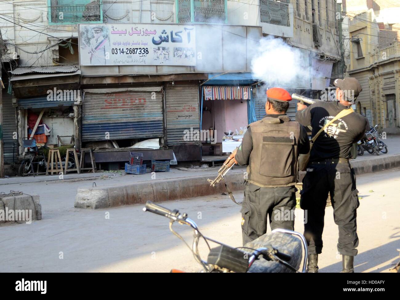 Hyderabad, Pakistan. 09th Dec, 2016. A police man fire tear gas on the ...