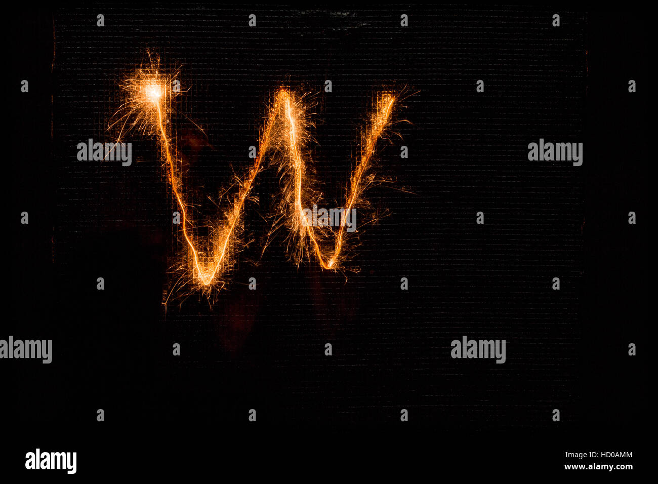 Letter W made of sparklers on black Stock Photo - Alamy