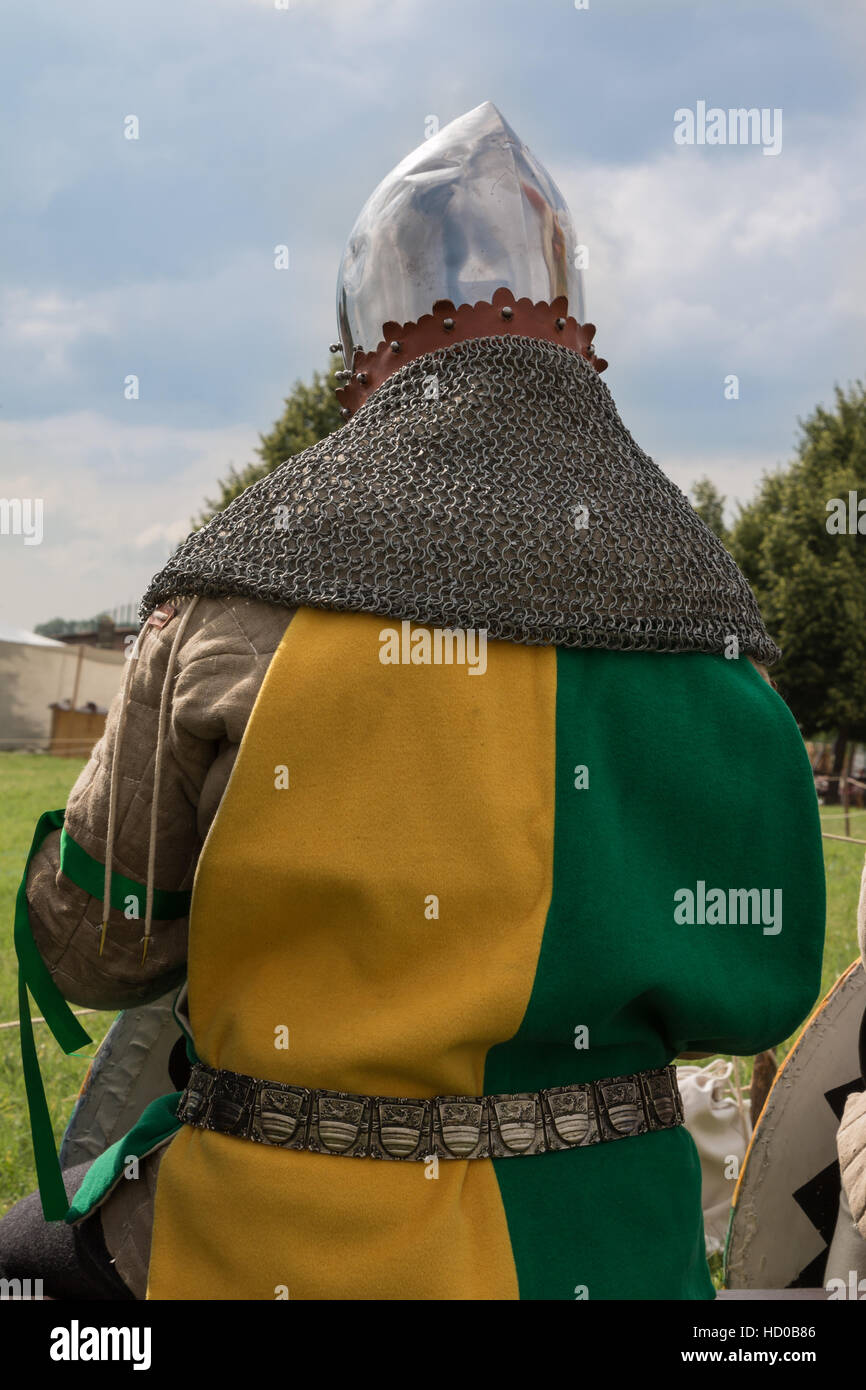 Knight with Helmet and Yellow and Green Clothes seated on a Chair ...
