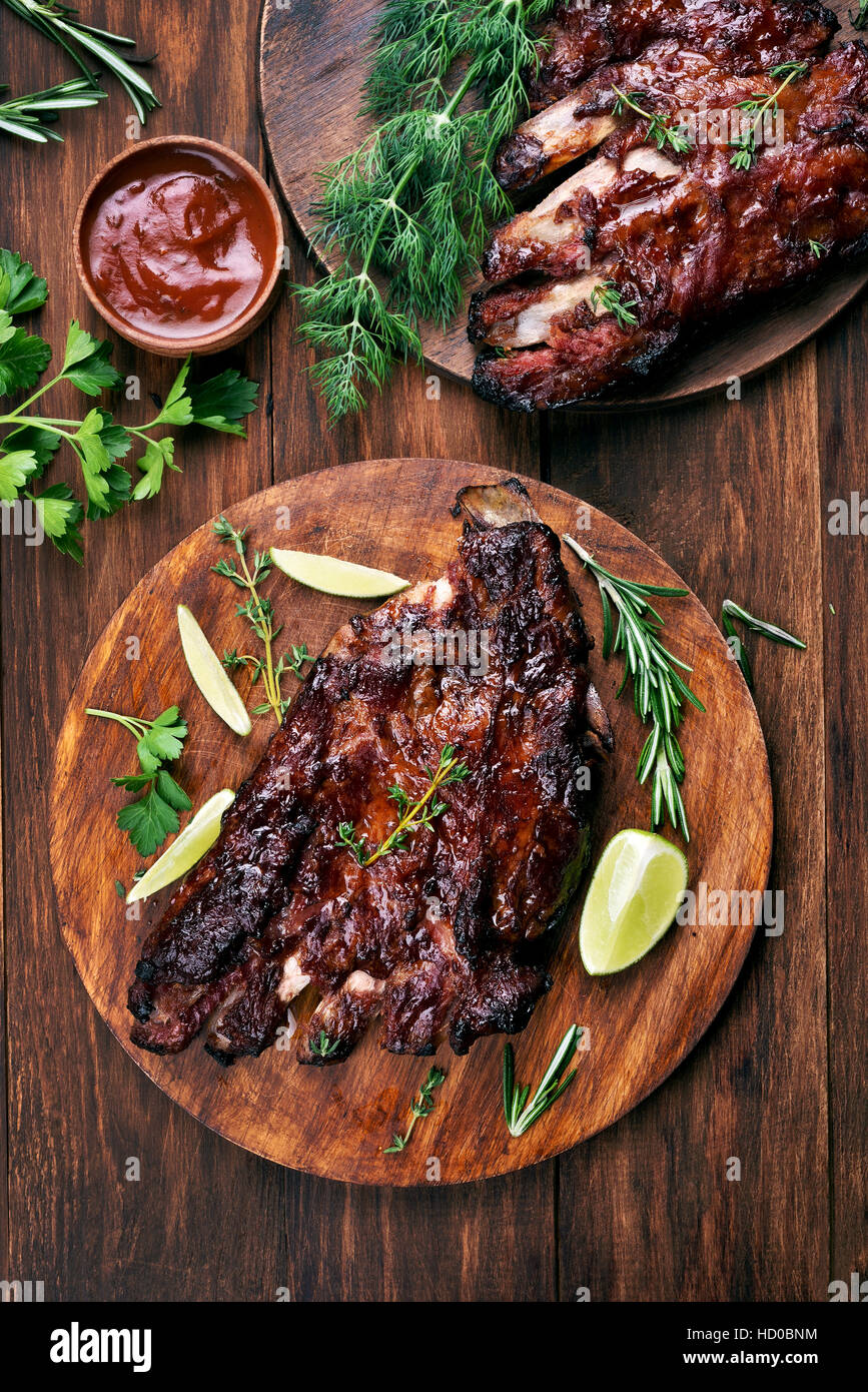 Barbecue pork ribs on wooden board, top view Stock Photo - Alamy