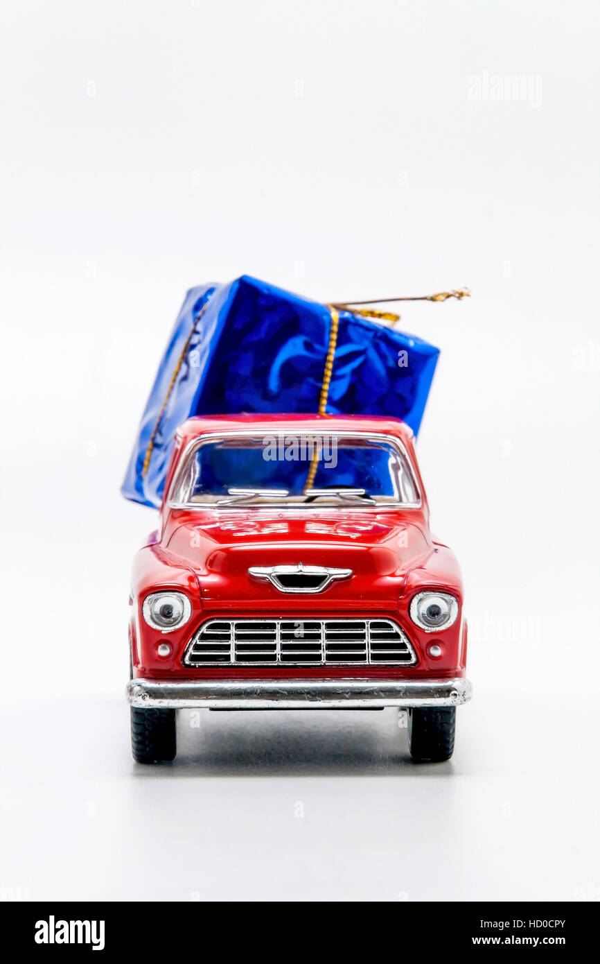 red retro car pickup with a blue gift box isolated Stock Photo - Alamy