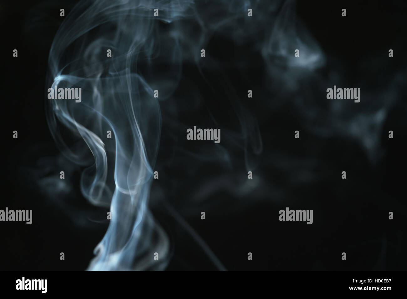 real blue smoke over black background Stock Photo - Alamy
