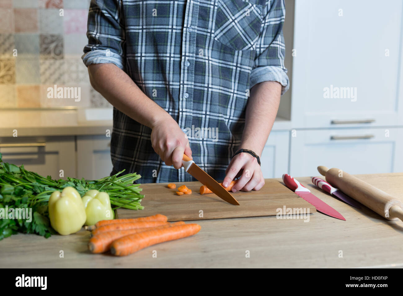 cooking, food and home concept - close up of male hand cutting ...