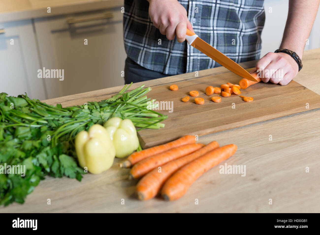 cooking, food and home concept - close up of male hand cutting ...