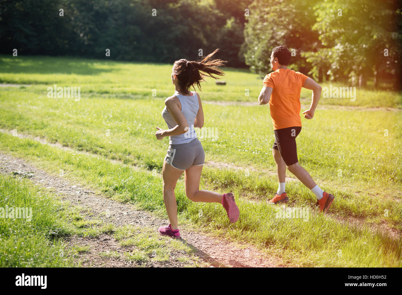 Couple jogging and running outdoors in nature Stock Photo - Alamy