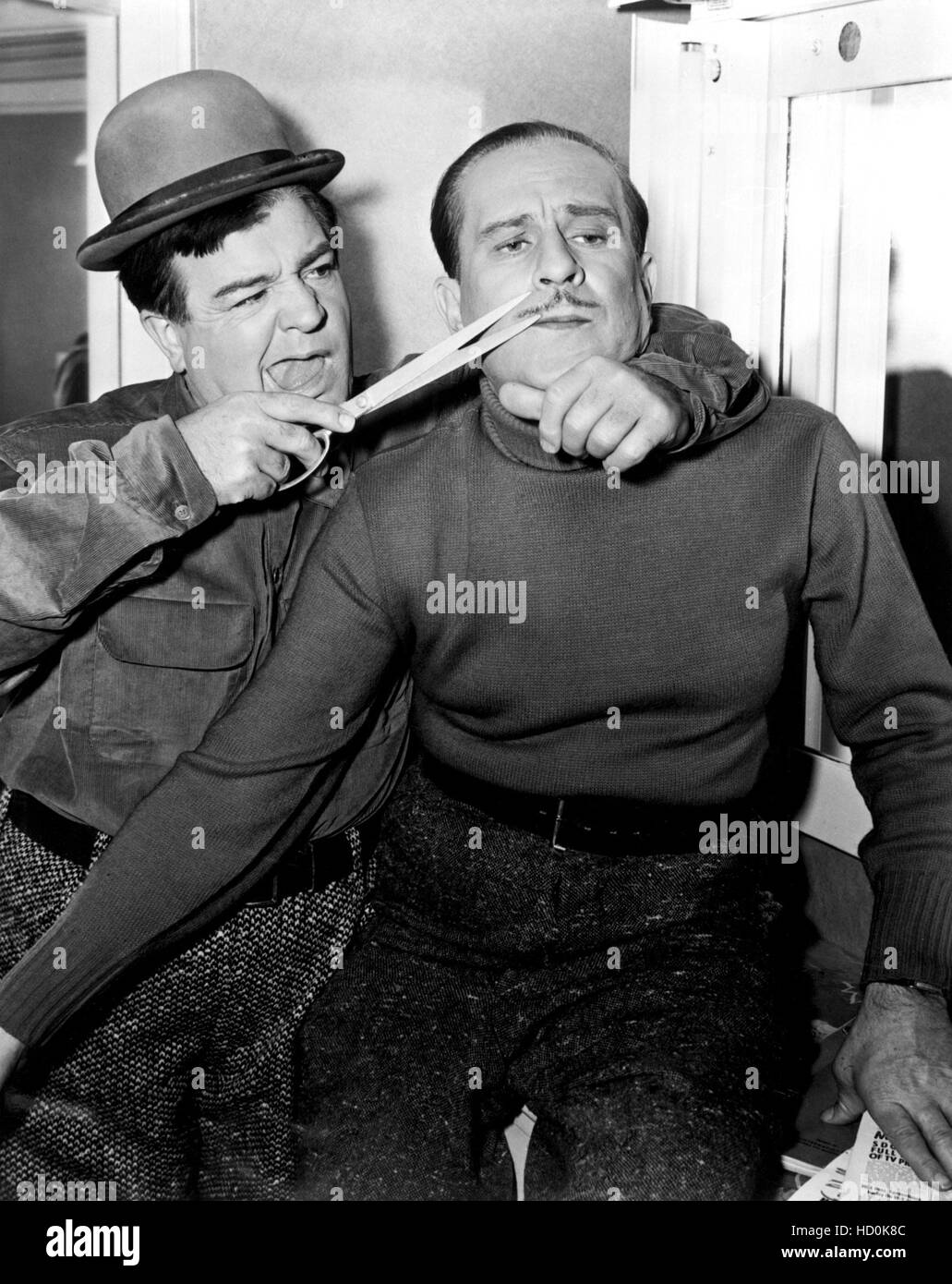 LOU COSTELLO trims partner BUD ABBOTT's [Abbott and Costello] moustache ...