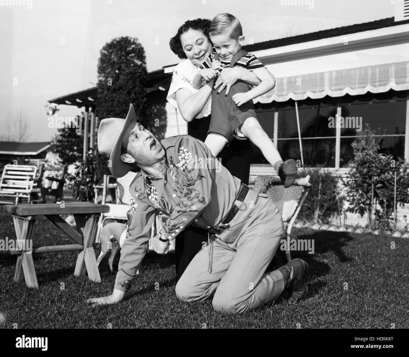 BUD ABBOTT, BETTY ABBOTT and BUD ABBOTT, JR. play in their garden, 7/13 ...