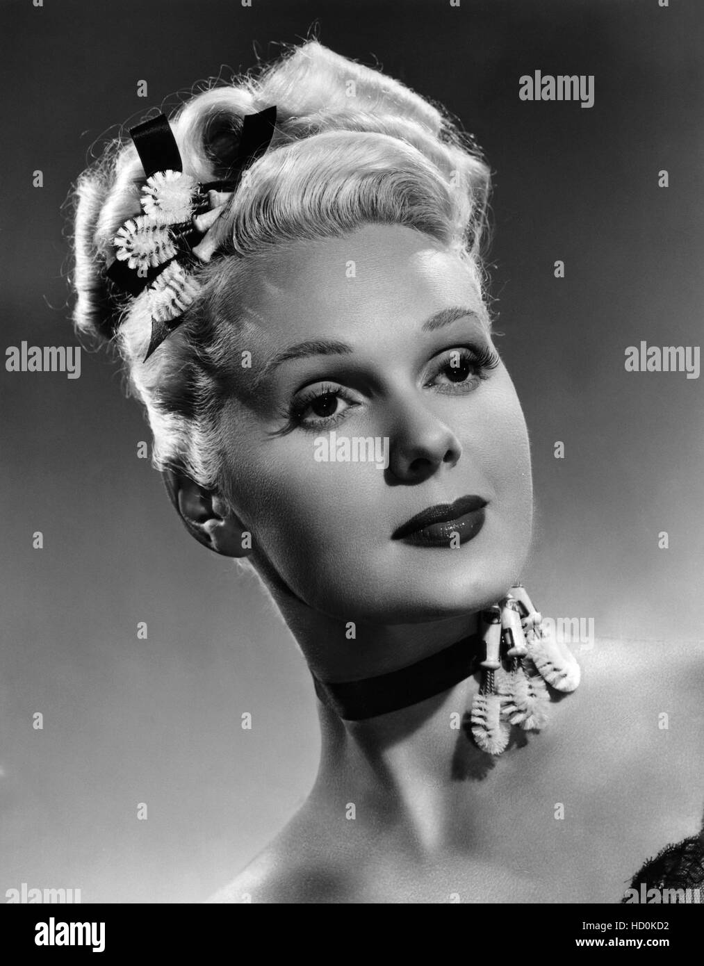 Adele Jergens with miniature brushes adorning her coiffure and neck ...