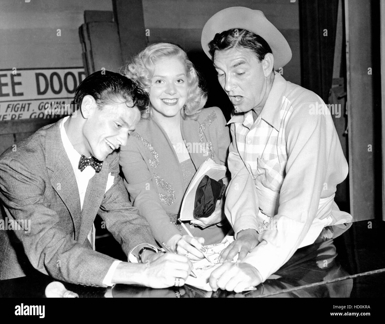 From left: Frank Sinatra, Alice Faye autographing the apron Ed Gardner ...
