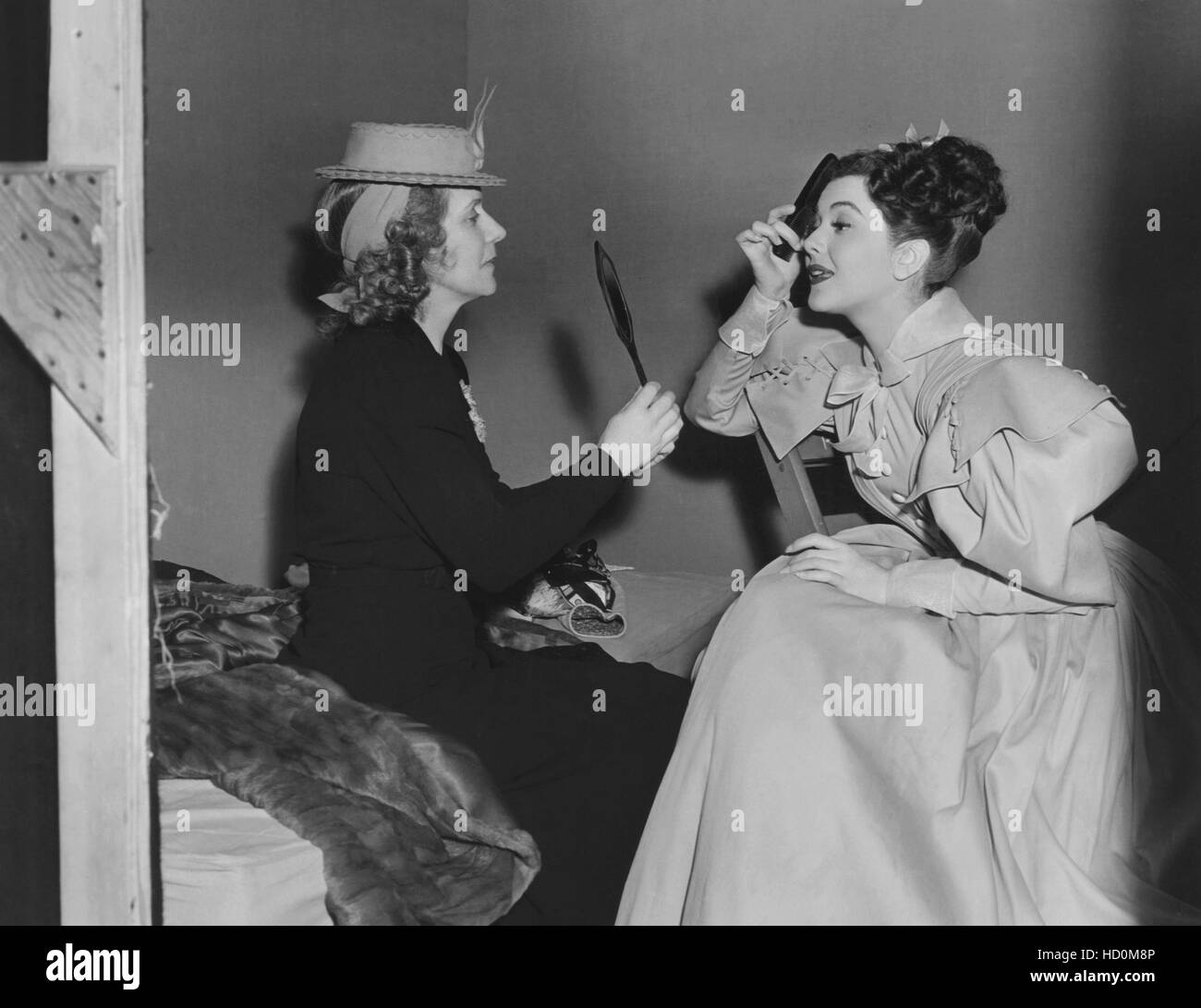 From left: Mrs. Lucille Rutherford holds the mirror for her daughter ...