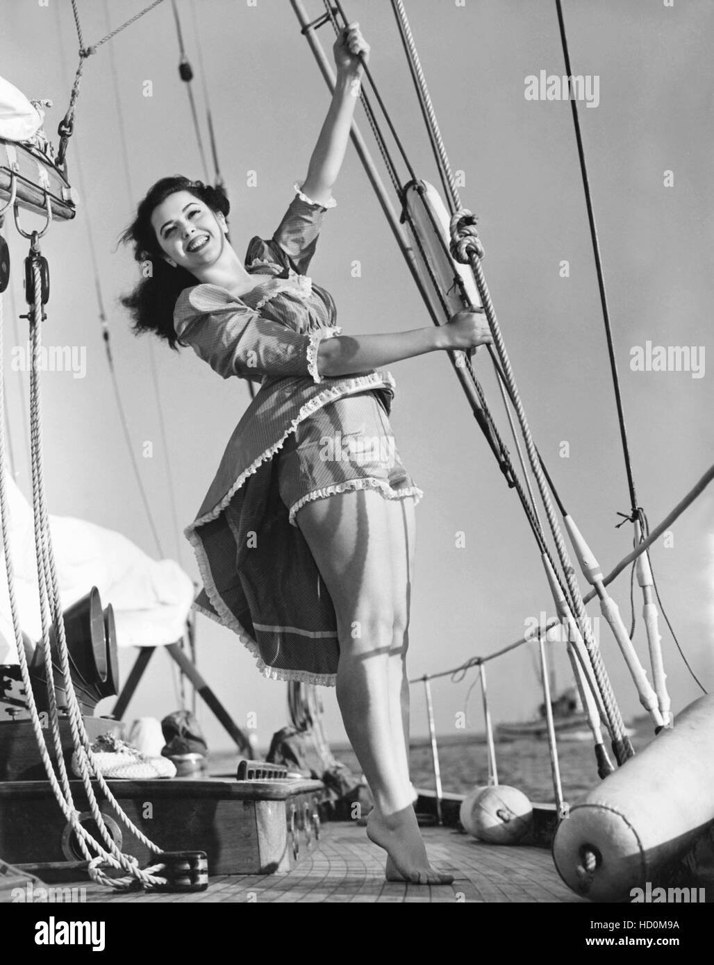 Ann Rutherford, modeling a blue and white taffeta sunsuit by Lanz of ...