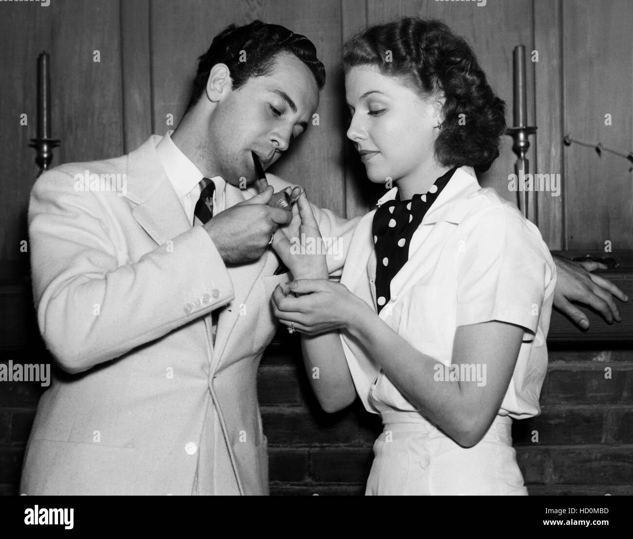Ann Sheridan (right) lighting the pipe of her husband Edward Norris, 1936 Stock Photo - Alamy