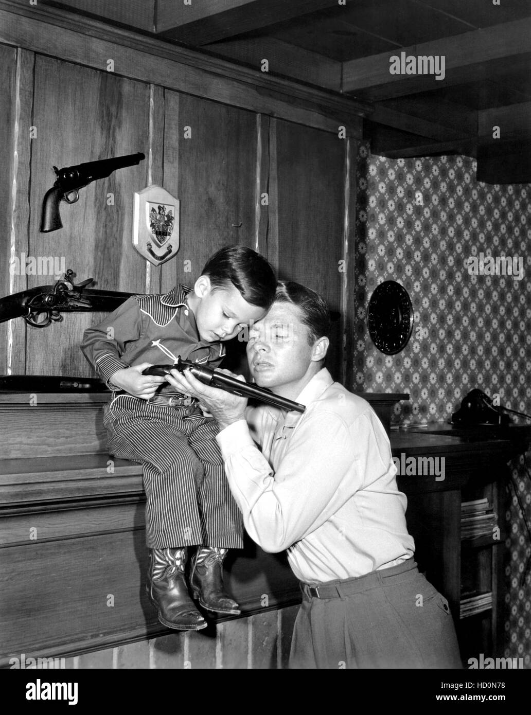 From left: Terry Michael Murphy, Audie Murphy, looking at pistol from ...