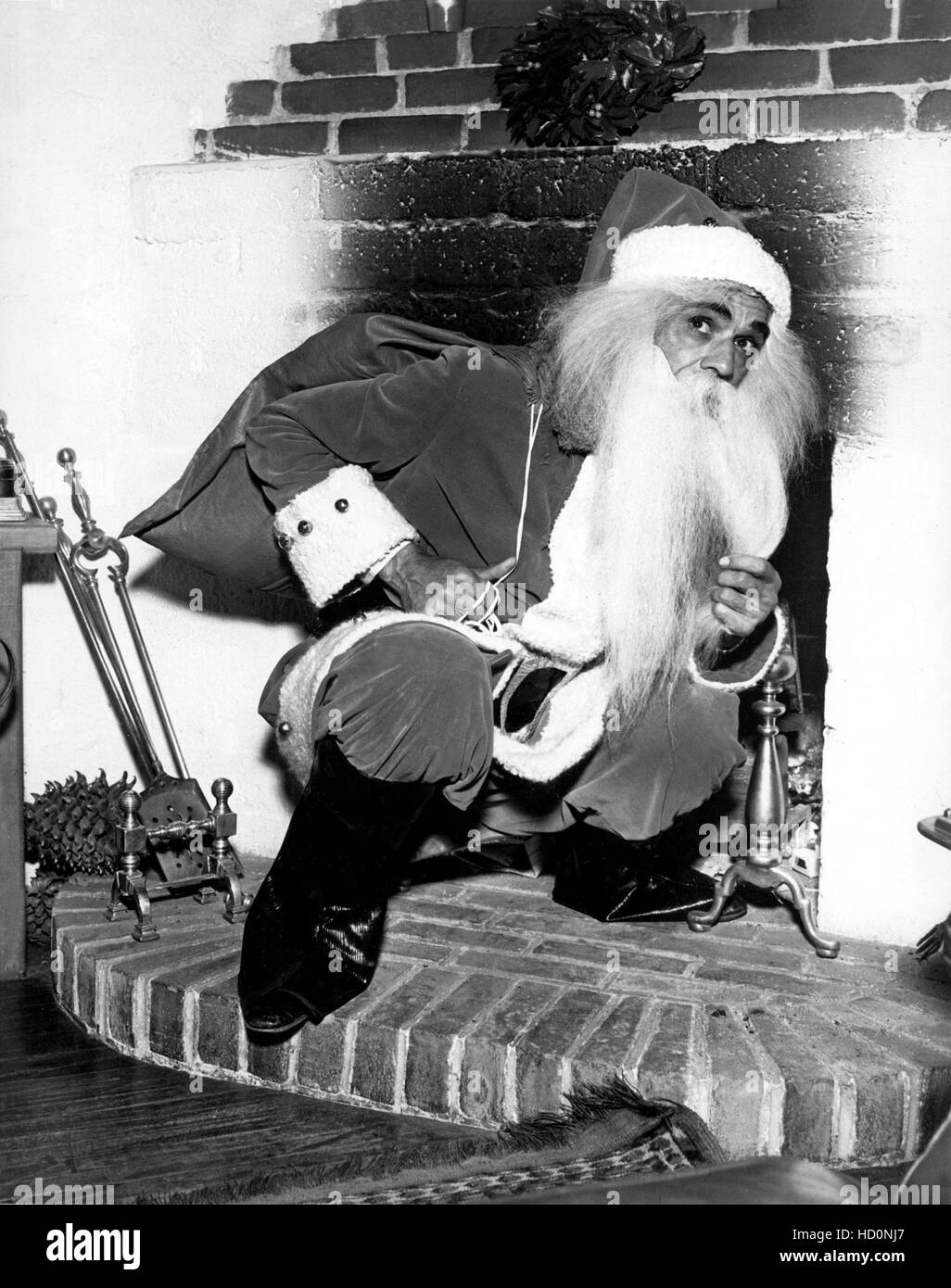 Boris Karloff as Santa Claus emerging from the fireplace Stock Photo ...