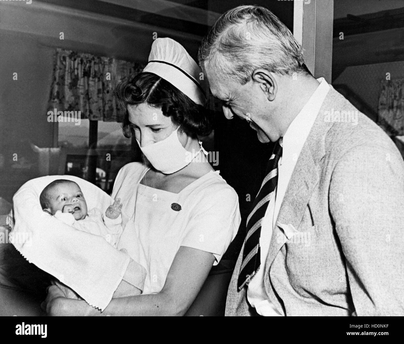 Sara Jane Karloff, held by Nurse Eleanor Lambert is shown to proud ...