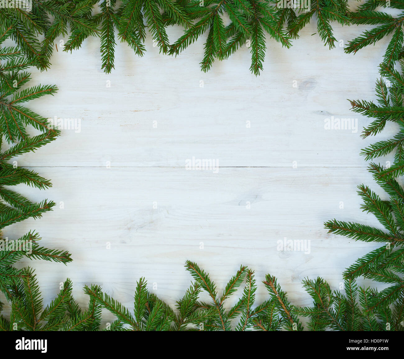 Christmas tree branches on white wooden texture ready for your design ...