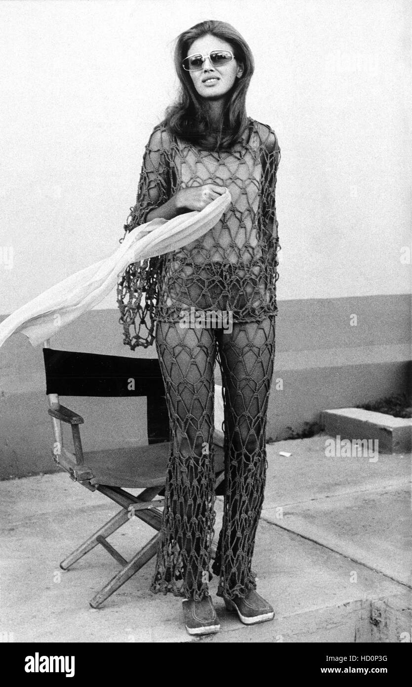 Britt Ekland relaxing in Salmon colored fishnet on the set of STILETTO ...