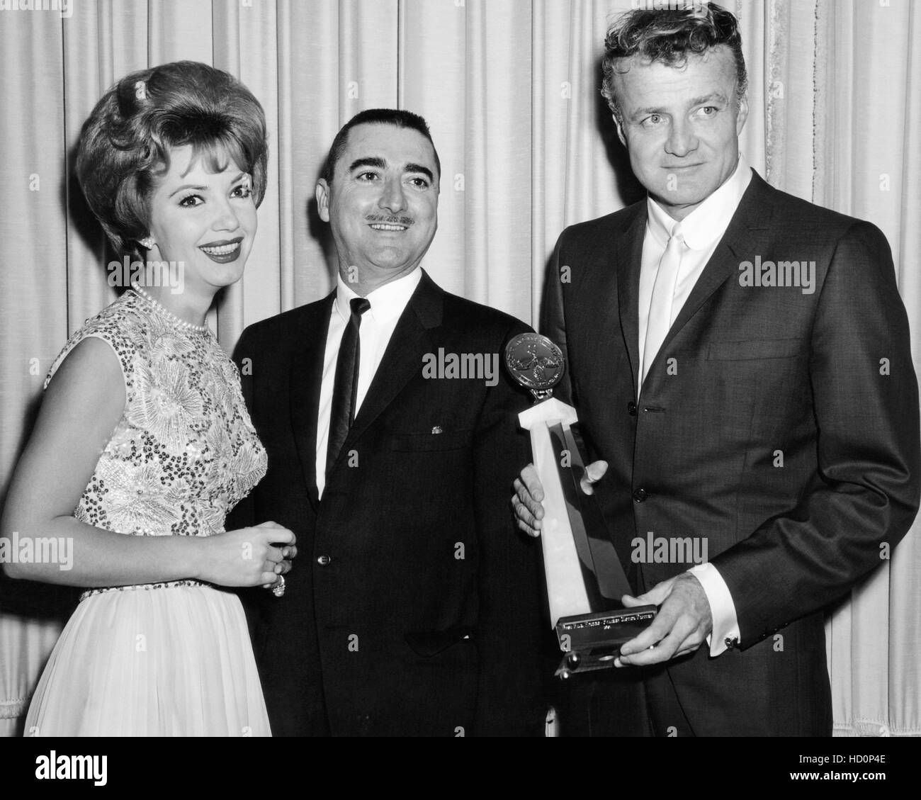 Ruta Lee, (left) and Brian Keith, (right) present Philip Anderson the ...