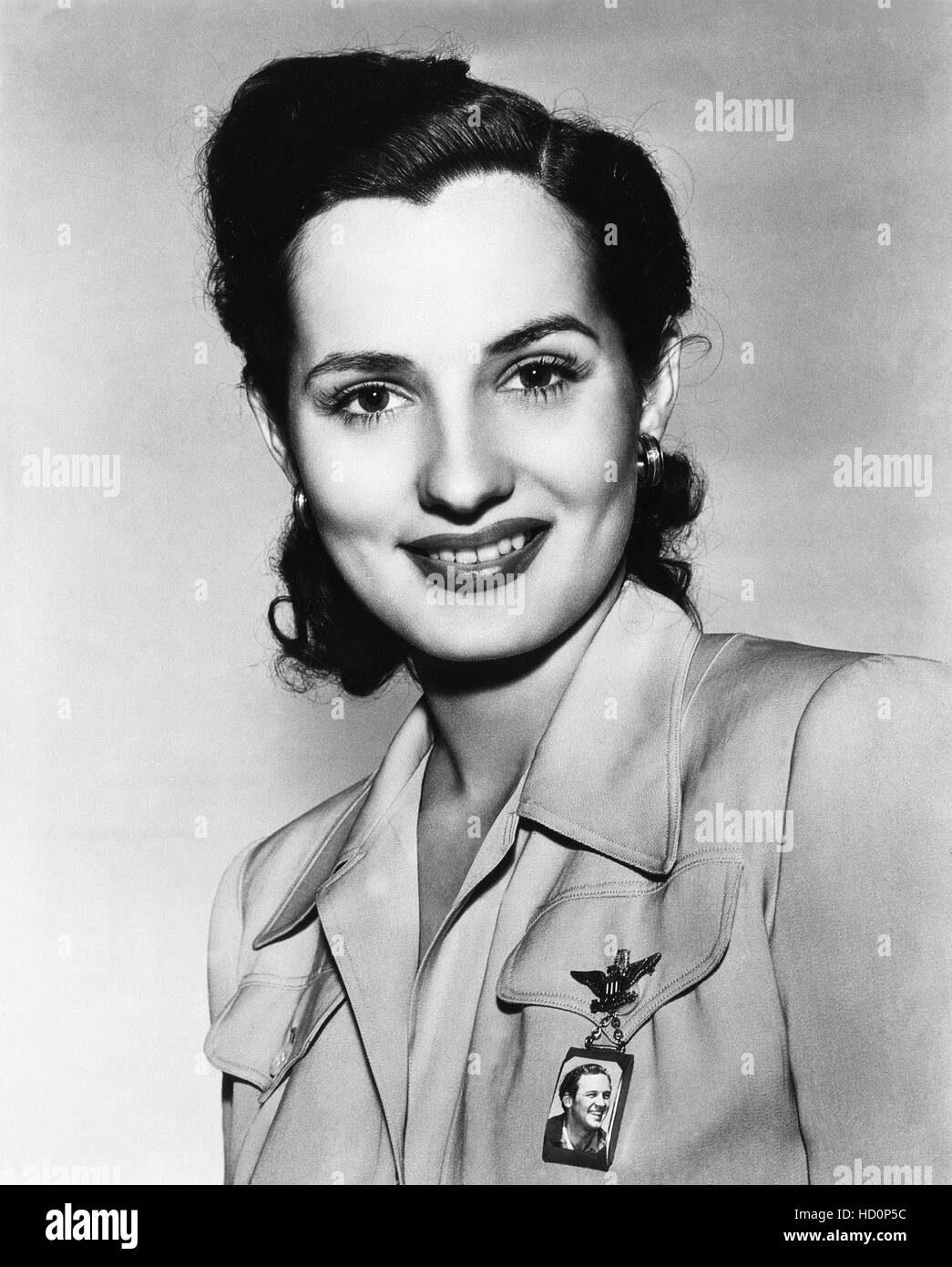 Brenda Marshall, wearing a photo of her husband, William Holden, who is ...