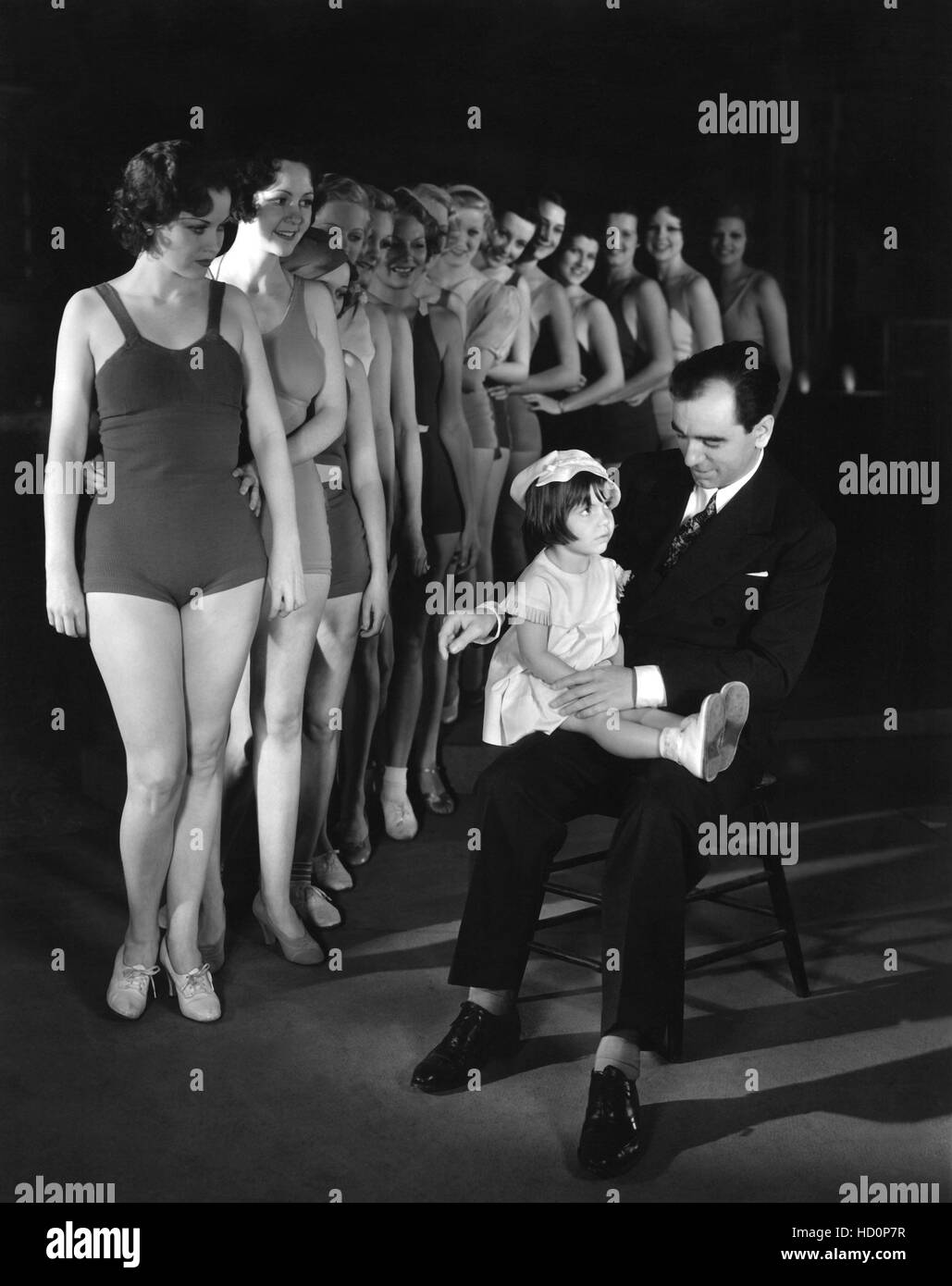 GOLD DIGGERS OF 1933, Shirley Wilson sits on director Busby Berkeley's ...