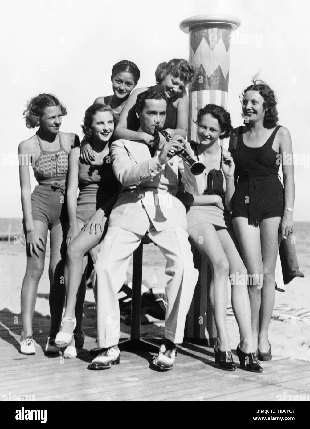 Charles 'Buddy' Rogers, surrounded by starlets, outside the Roney-Plaza ...