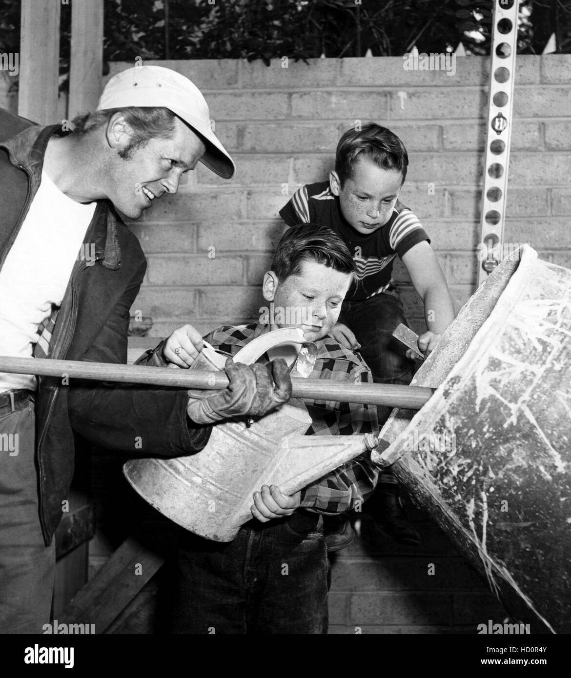 From left: Dan Duryea, Peter Duryea, Richard Duryea mixing cement, ca ...