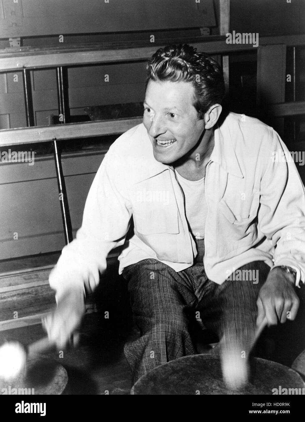 DANNY KAYE lets loose on the kettle drums during production break on A ...
