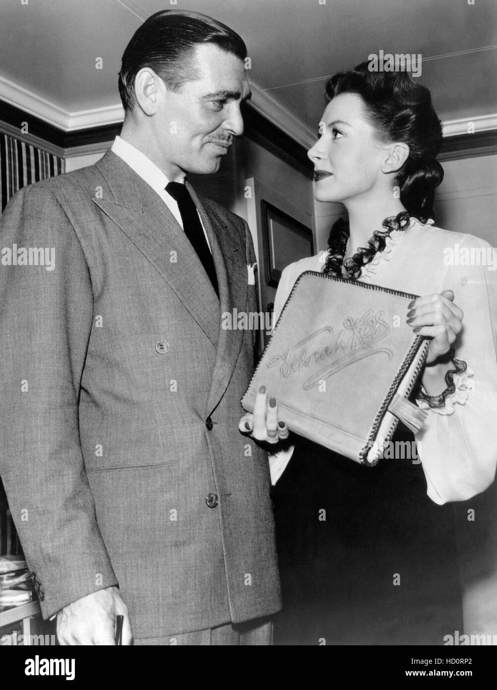 Clark Gable gives co-star Deborah Kerr a leather bound script binder ...