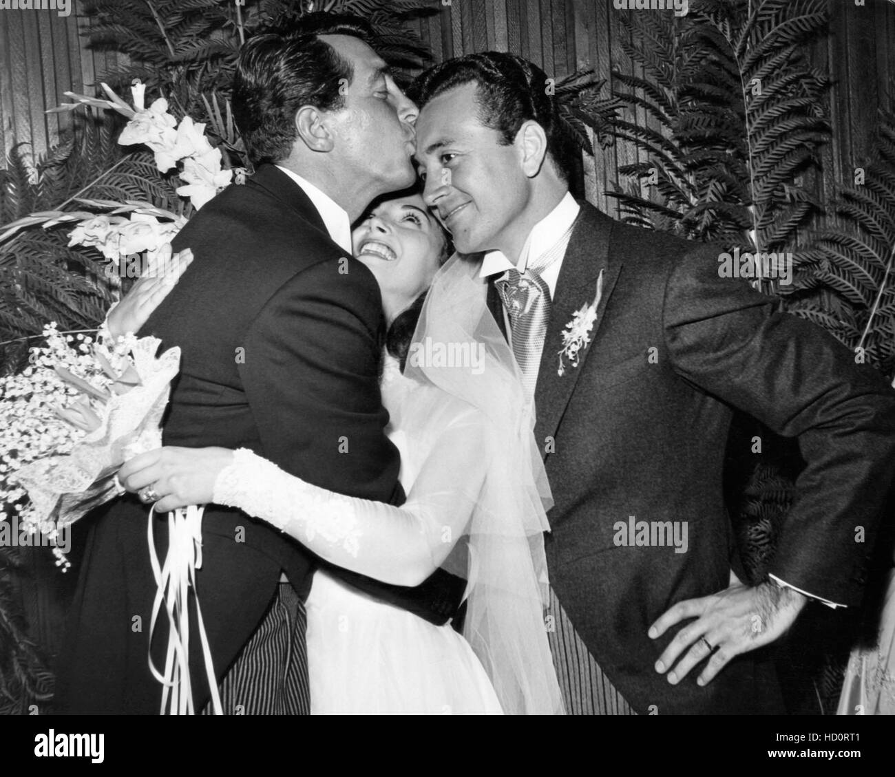 Dean Martin kisses Pier Angeli and Vic Damone on their wedding day ...