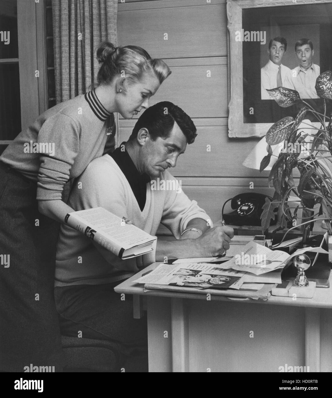 DEAN MARTIN and wife JEANNIE MARTIN do some paperwork at home. 1952 ...