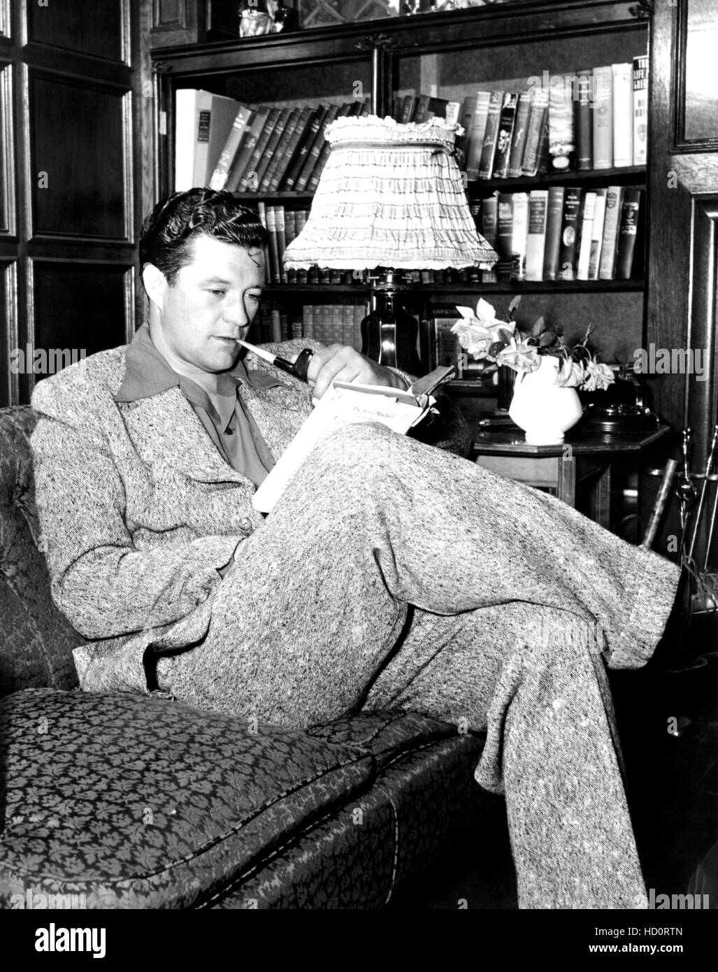 Dennis Morgan reading at home, Hollywood, California, ca. 1946 Stock ...