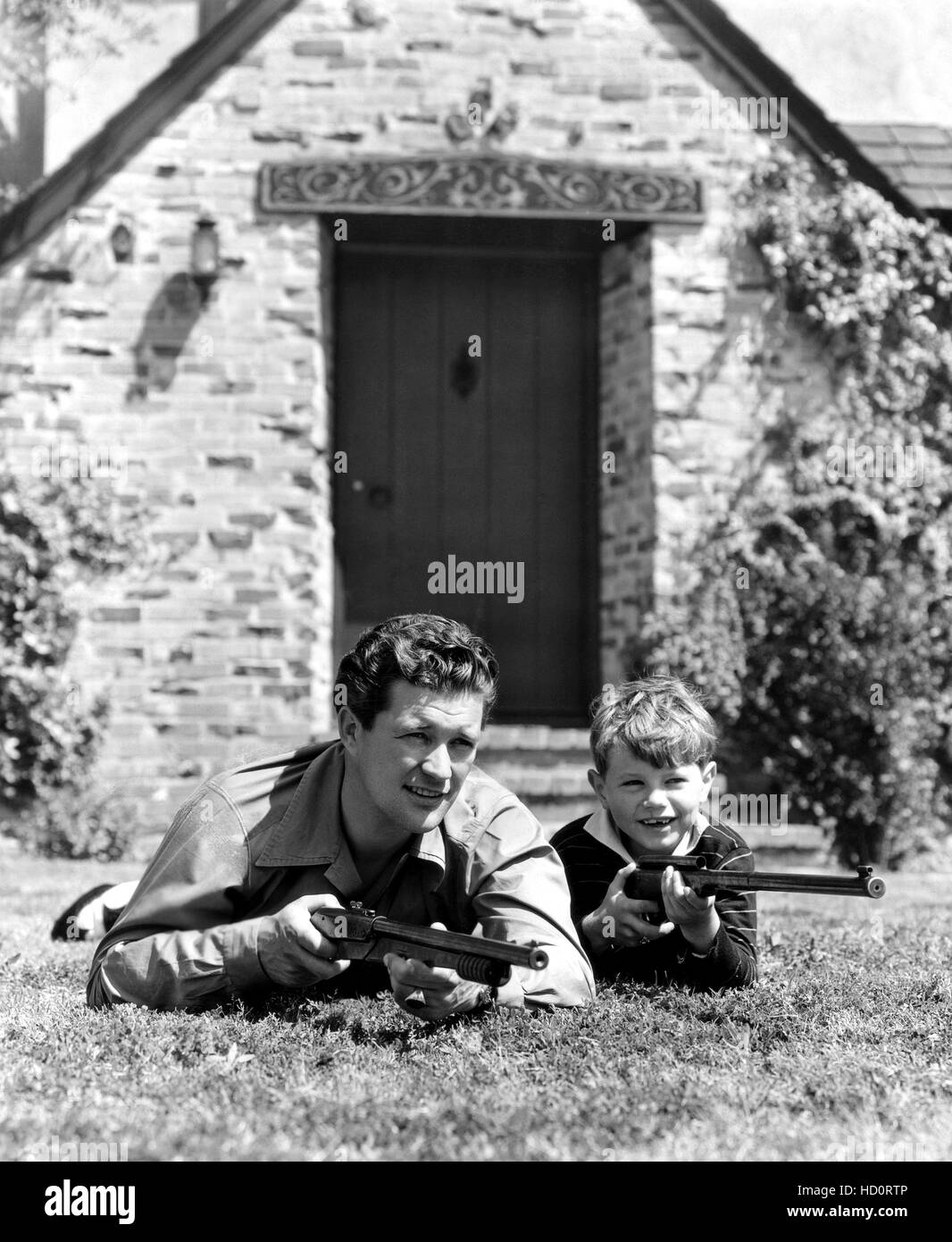 From left: Dennis Morgan playing with his son, Stanley, age seven, ca ...
