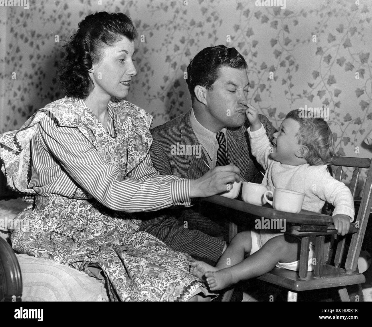 Dennis Morgan (center) during feeding time with son, James (right) and ...