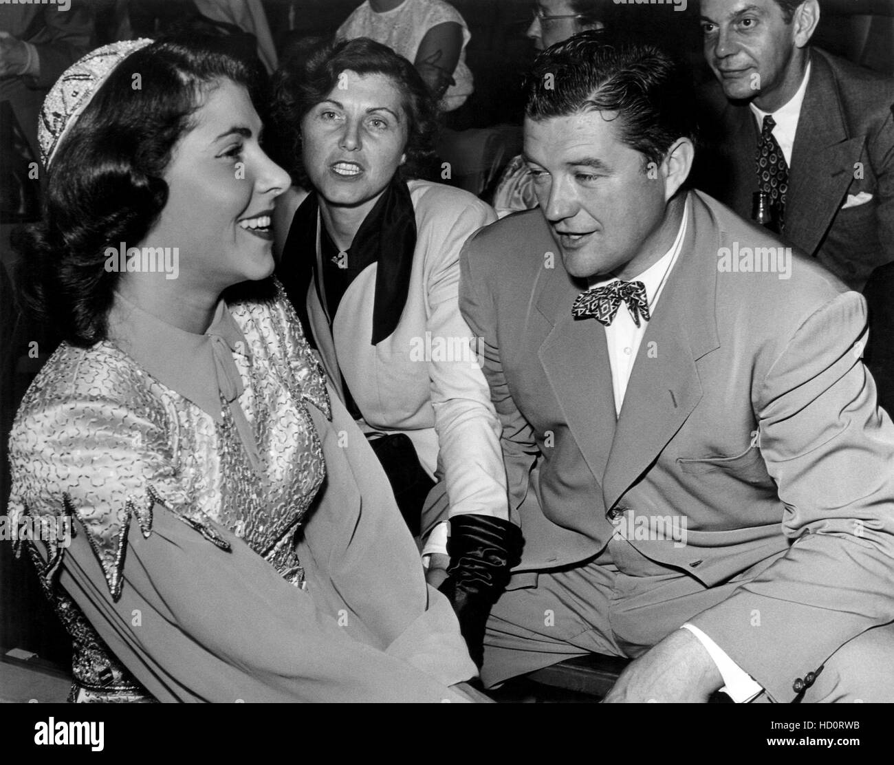 Lillian Morgan (back) and husband Dennis Morgan, talking to ice skater ...