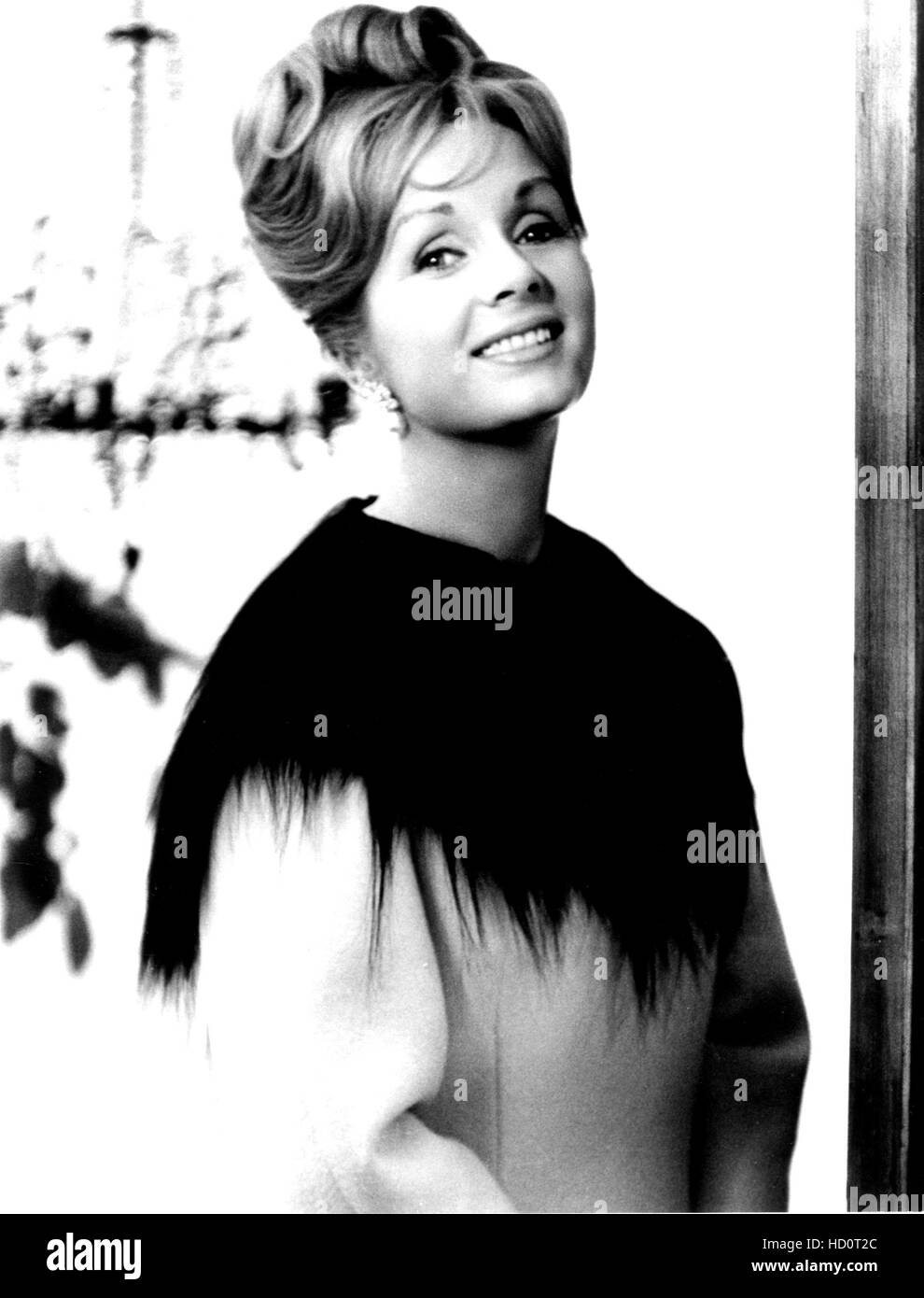 Debbie Reynolds, modeling a white coat with detachable monkey-fur ...