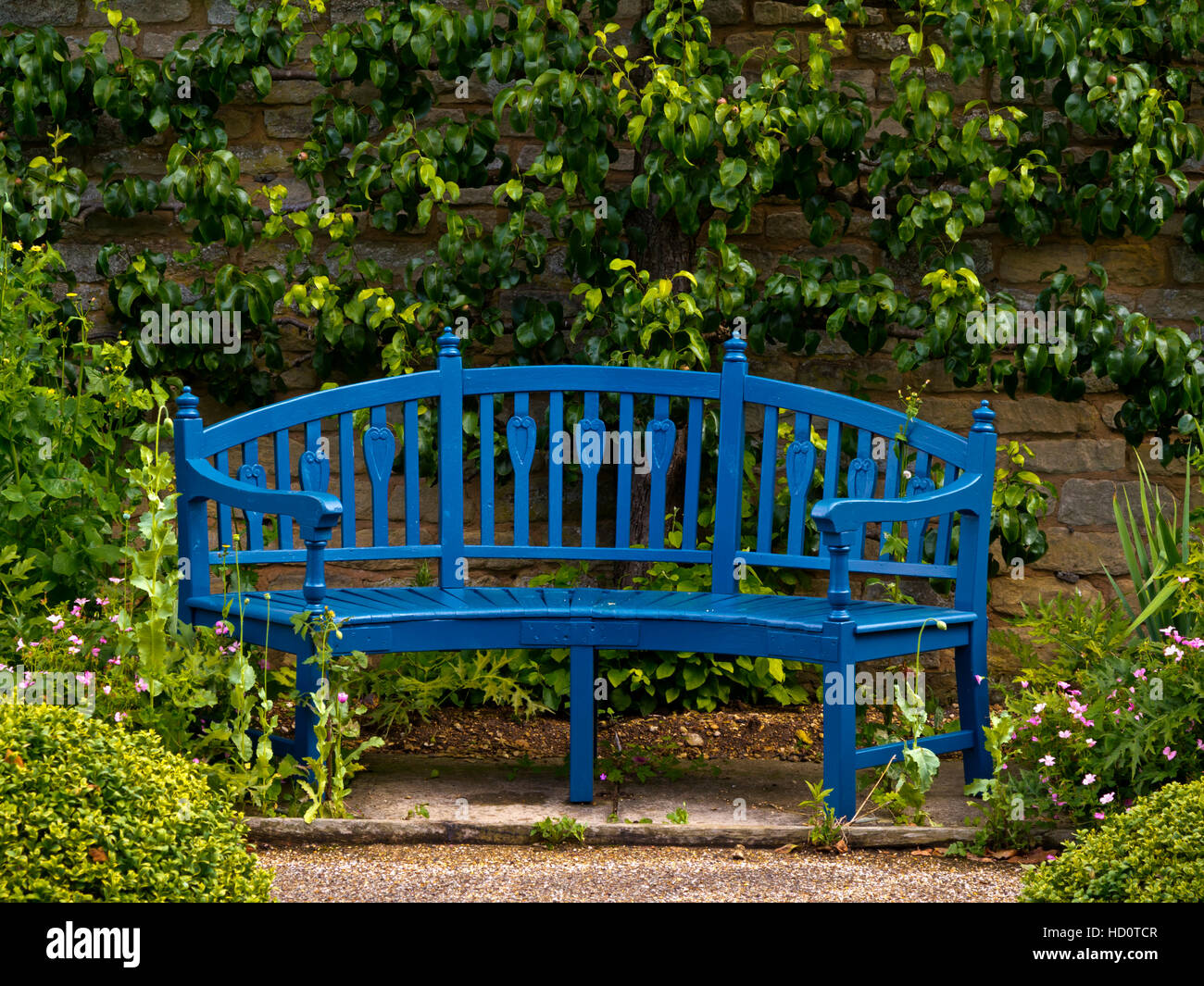 Curved blue wooden bench in the garden at Grimsthorpe Castle in ...