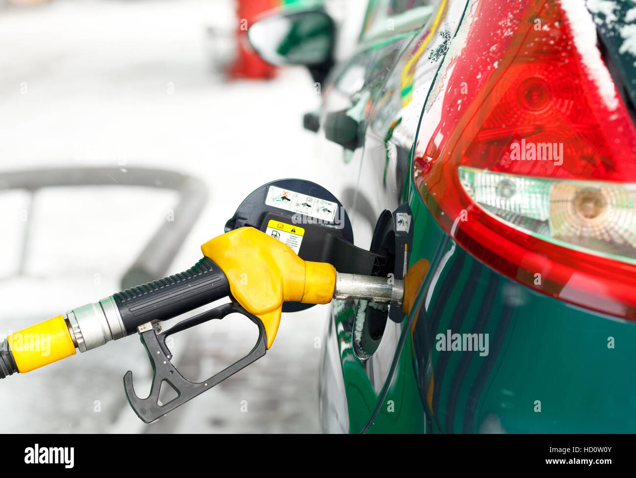 Car refueling on a petrol station in winter closeup Stock Photo - Alamy