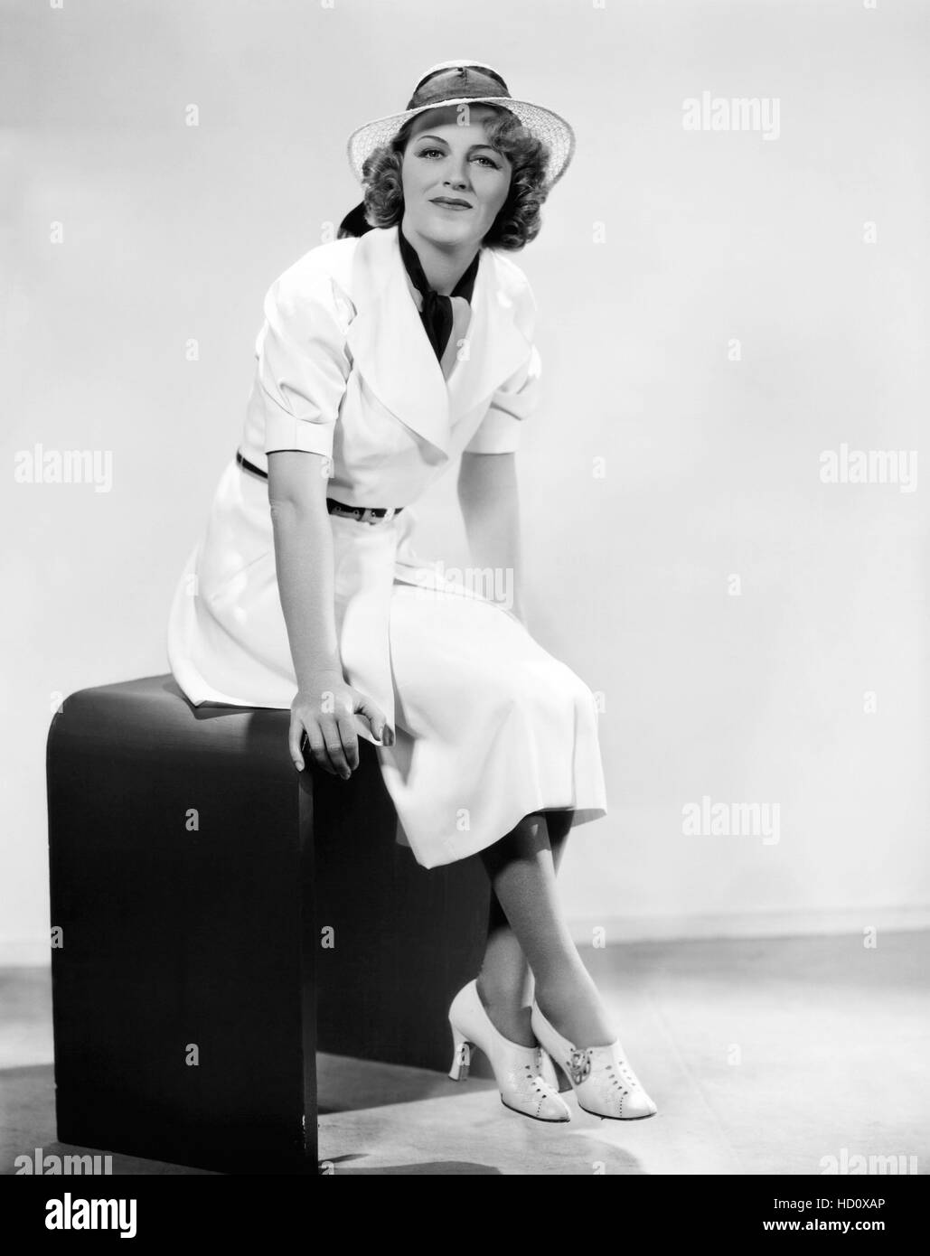Gracie Fields, wearing two piece outfit made of white shantung, ca ...