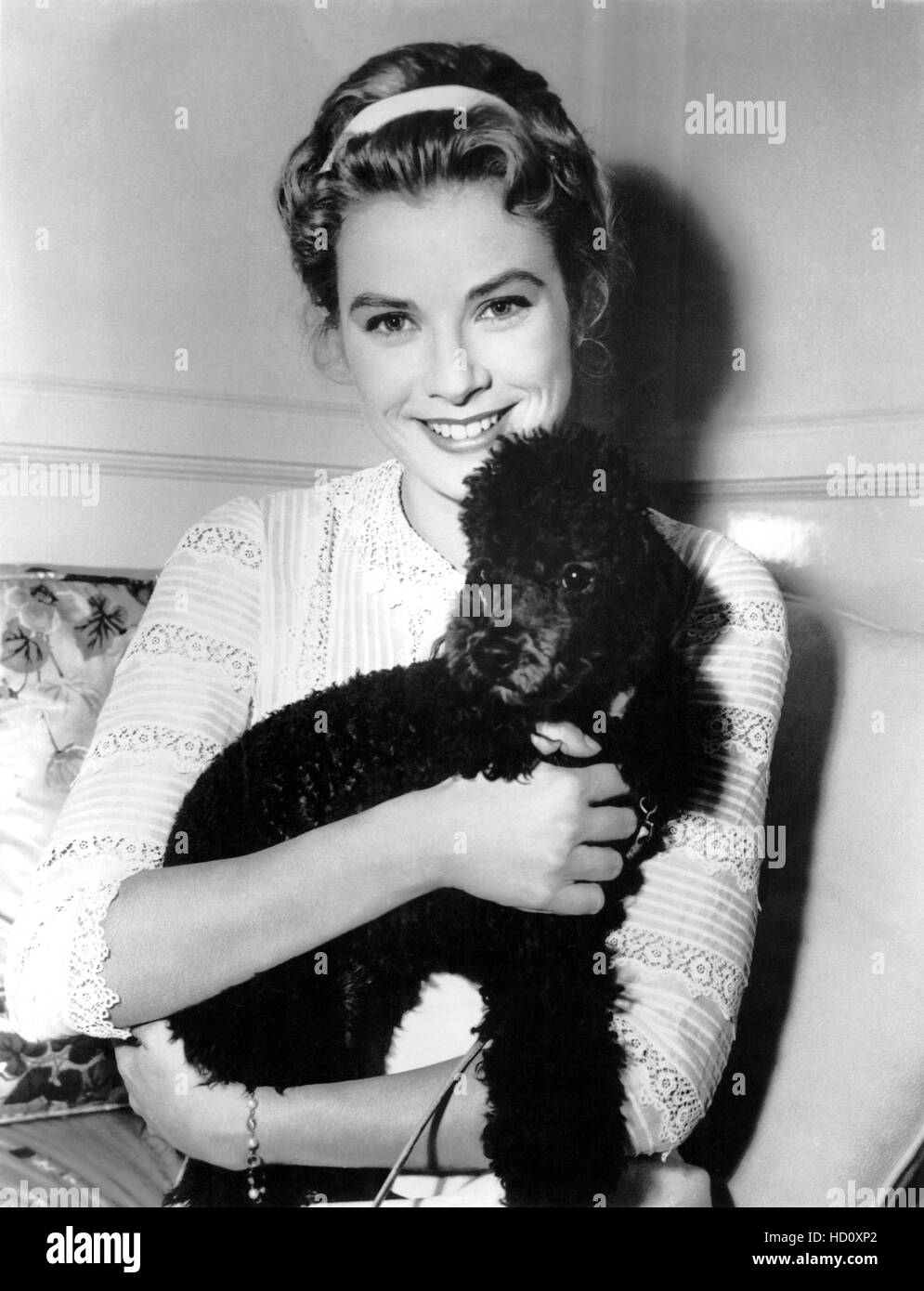 THE SWAN, Grace Kelly between scenes on set with her dog, Oliver, 1956 ...