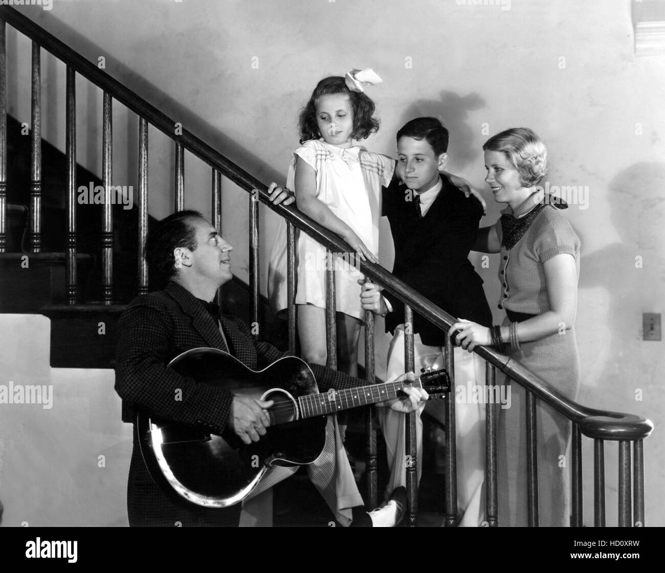 Groucho Marx at home serenading his family, Miriam Marx, Arthur Marx ...