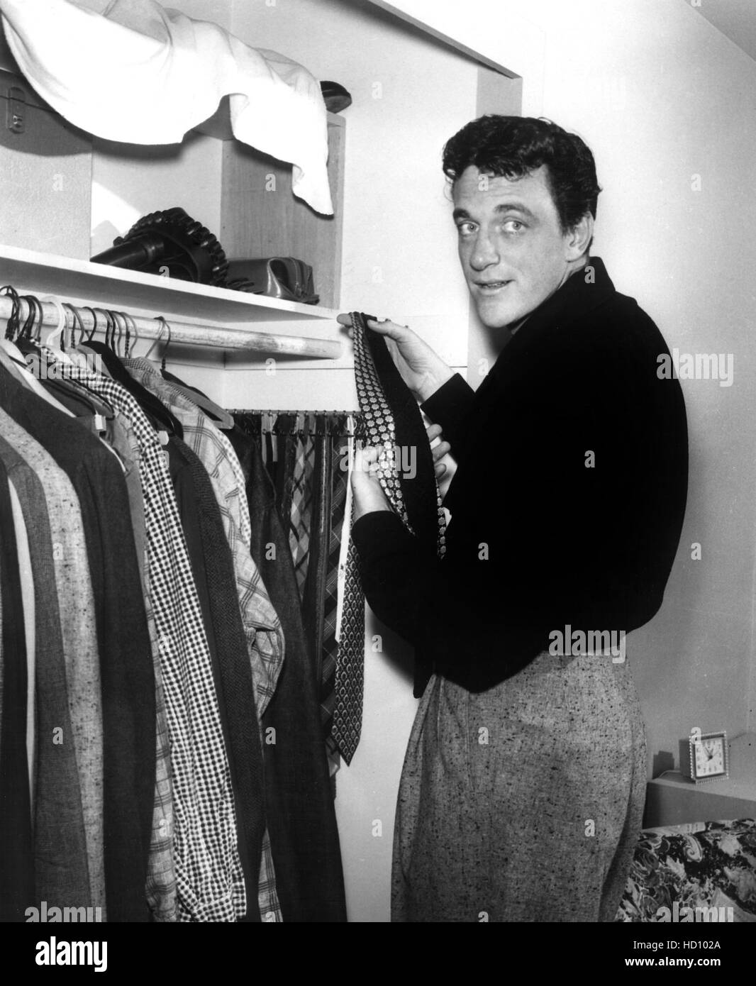 JAMES ARNESS at home selects an outfit from his king size closet, 1956 ...