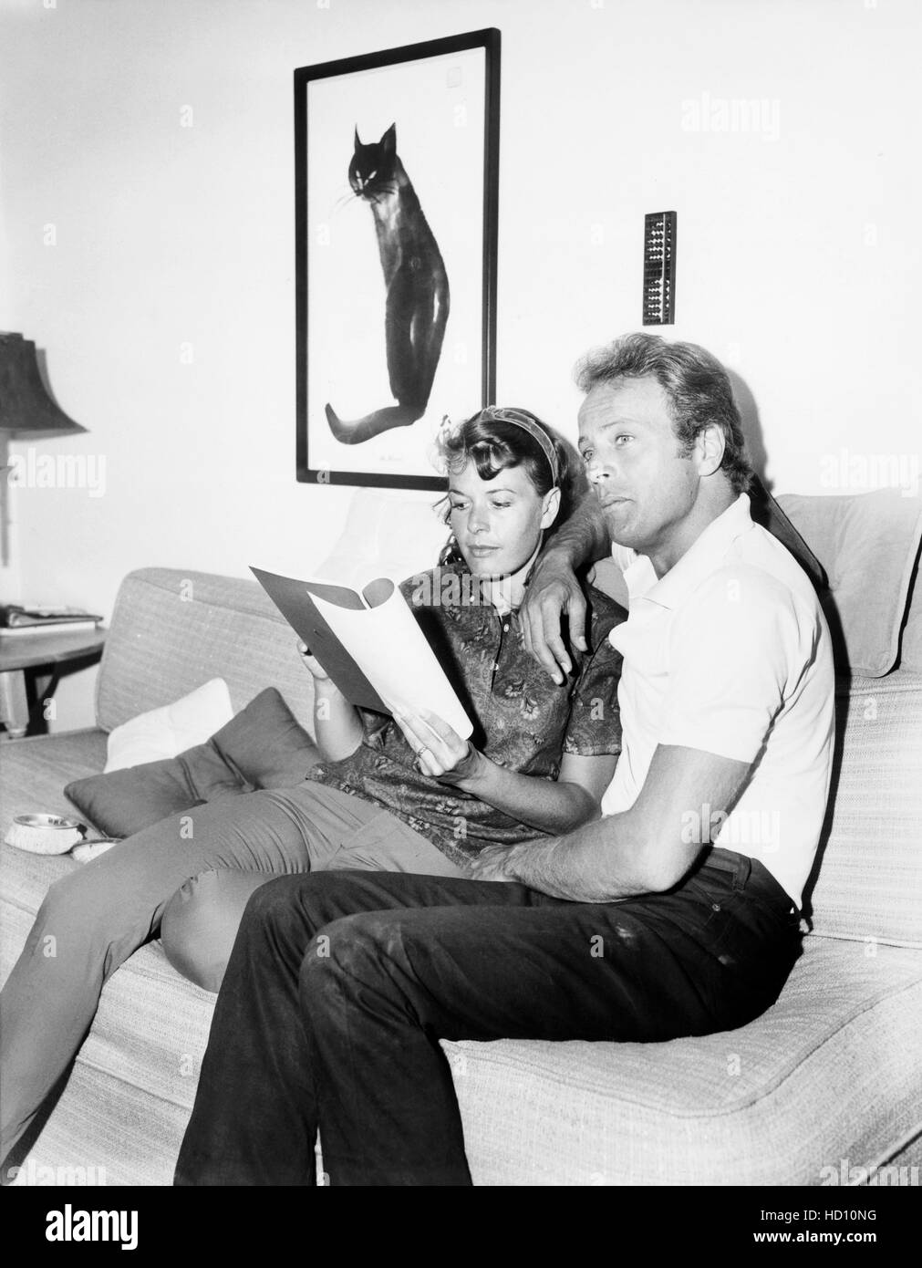 Jason Evers, right and his first wife, actress Shirley Ballard, studying Evers' WRANGLER script ...