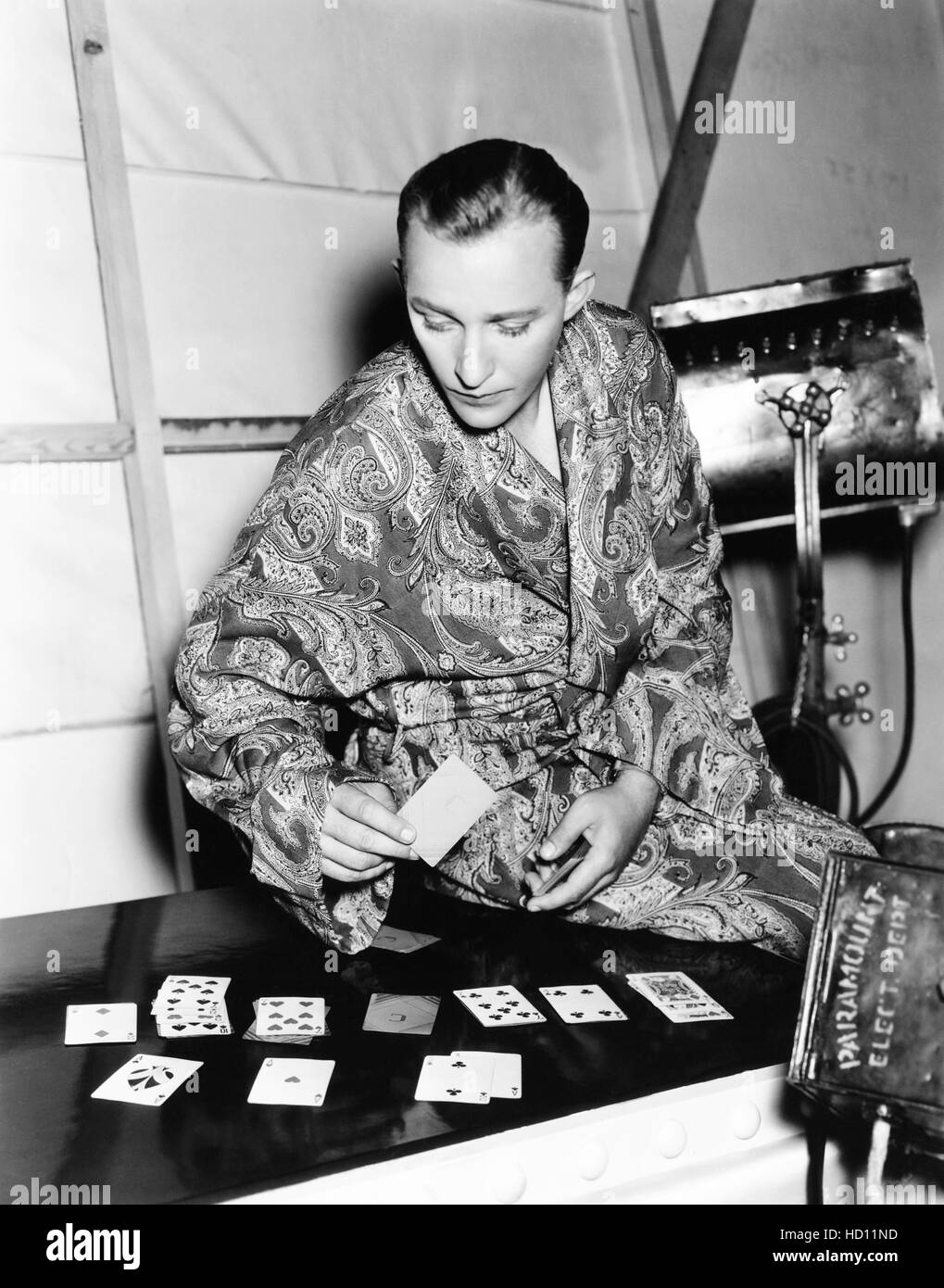 HERE IS MY HEART, Bing Crosby engages himself in a game of solitaire ...