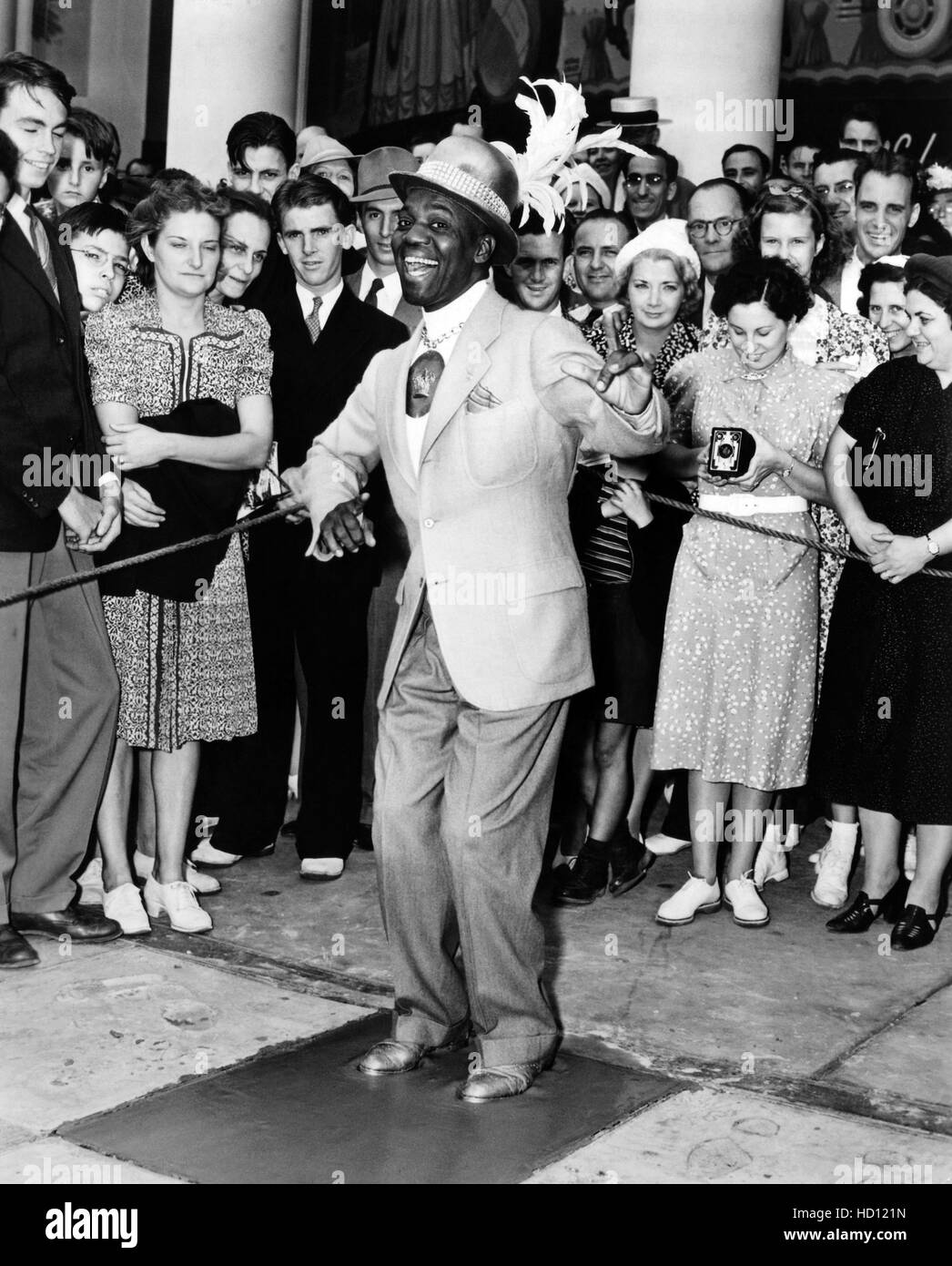 Bill Robinson, (aka Bill 'Bojangles' Robinson), putting his footprints ...