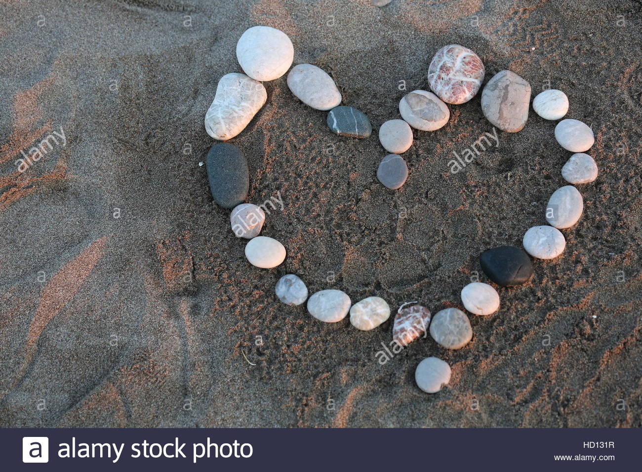 Sandy beach with pebble heart hi-res stock photography and images - Alamy